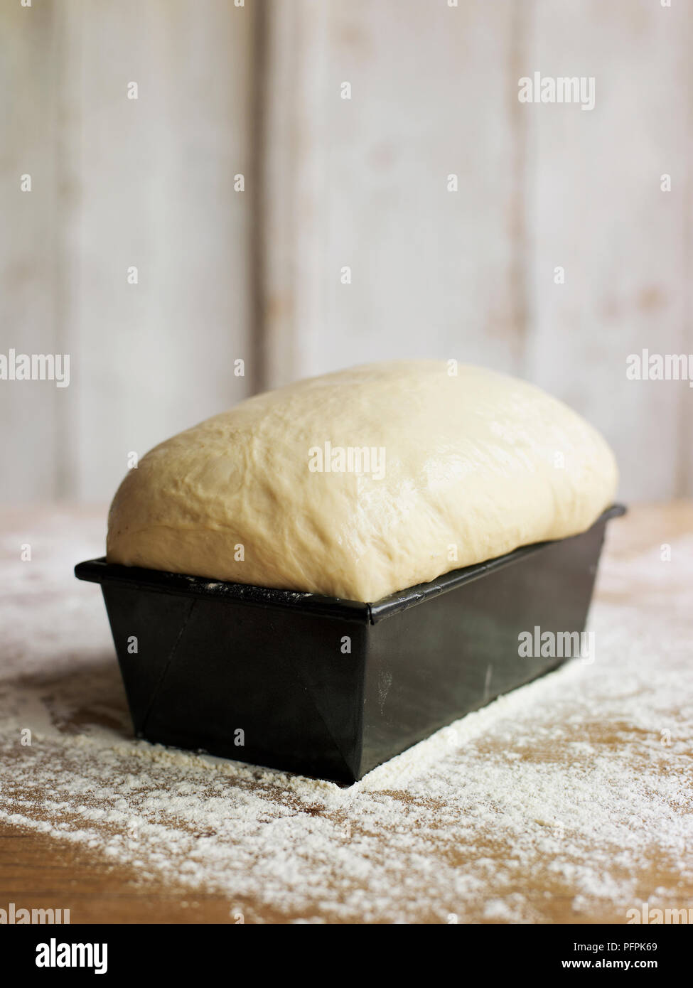 Risen bread dough in loaf tin Stock Photo - Alamy