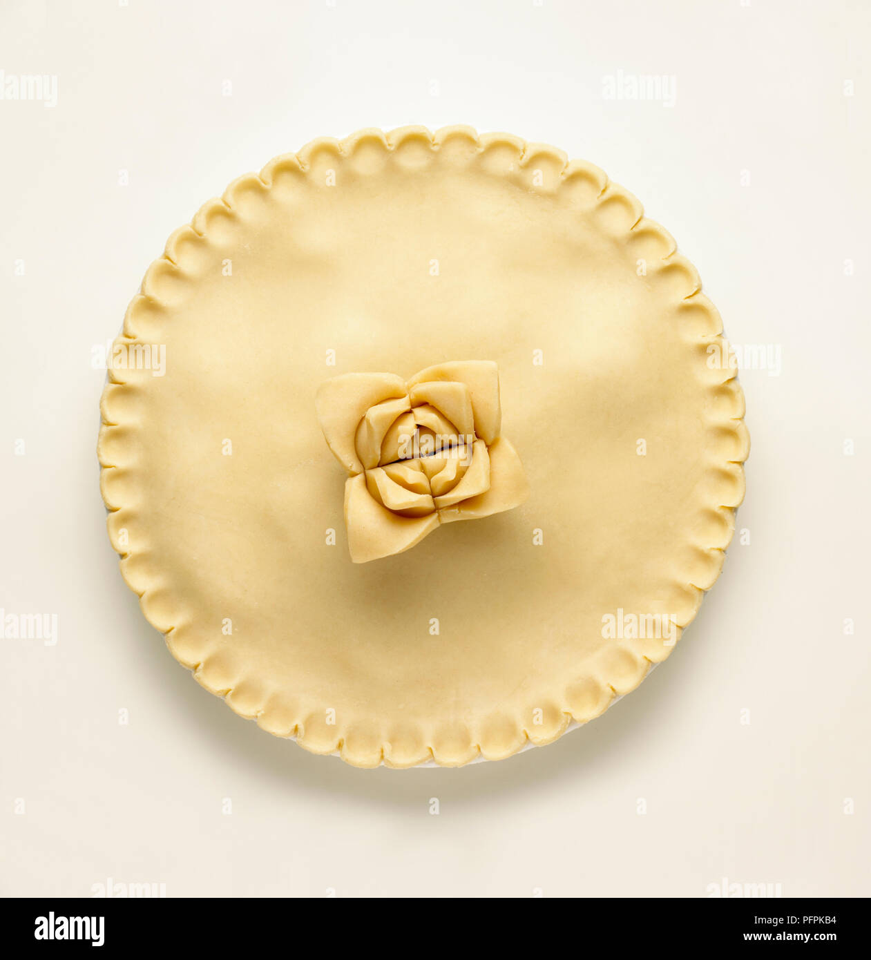 Pie with scalloped edge and decorated with pastry rose Stock Photo - Alamy