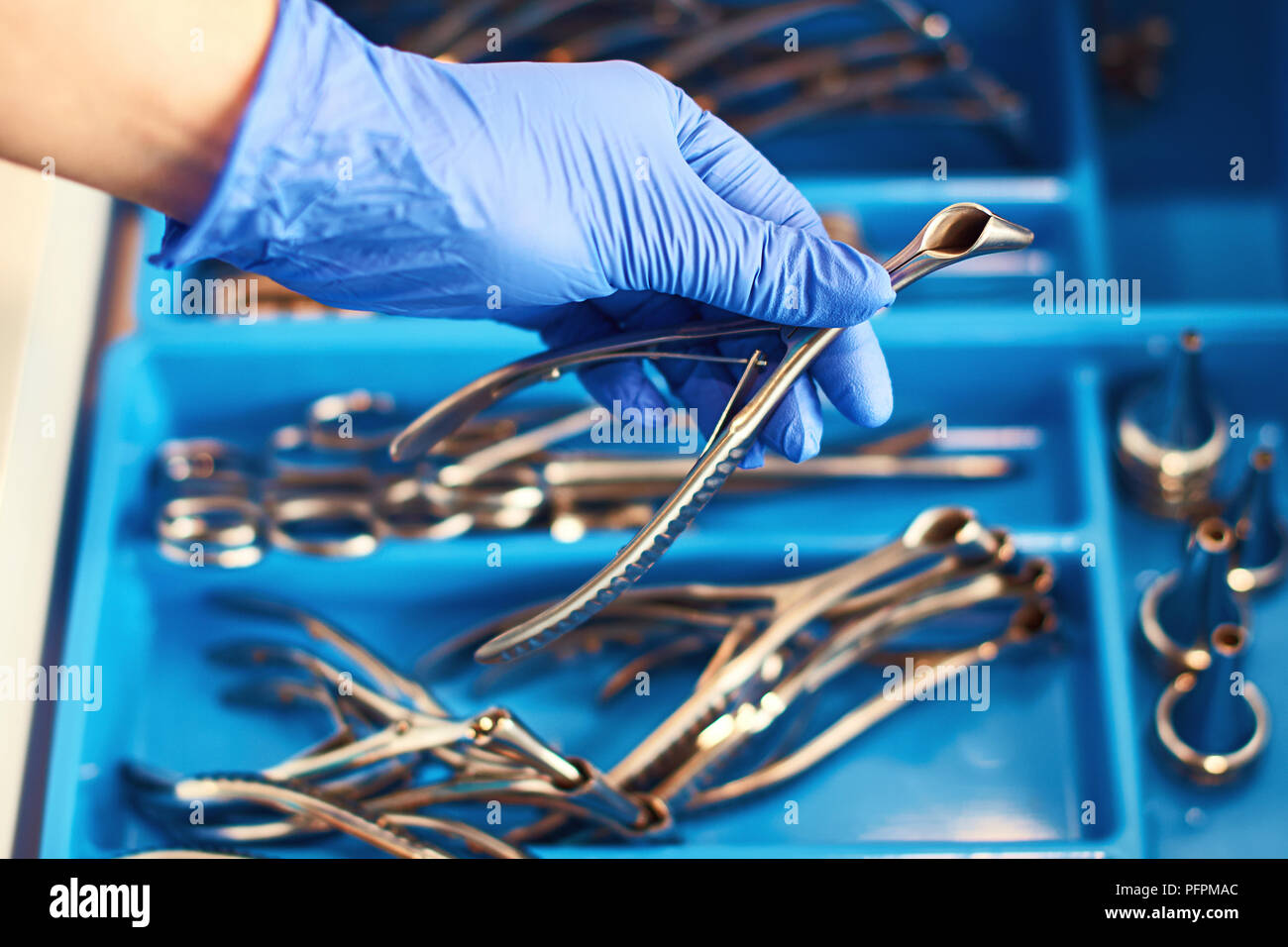 Doctors Hand In Disposable Nitrile Medical Gloves Holding A Nasal Speculum For Ent Examination