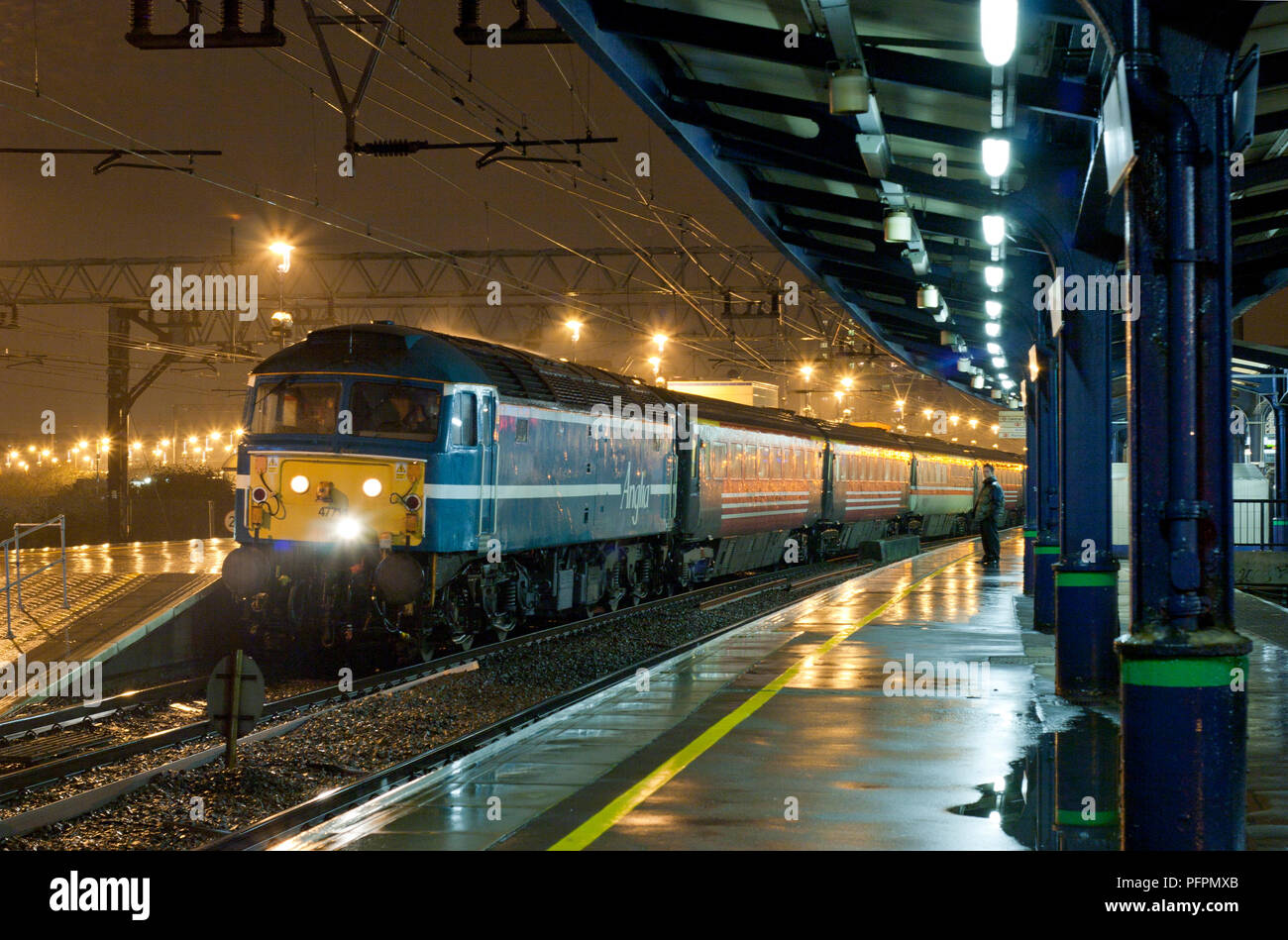 A class 47 diesel locomotive number 47714 pauses at a very wet ...