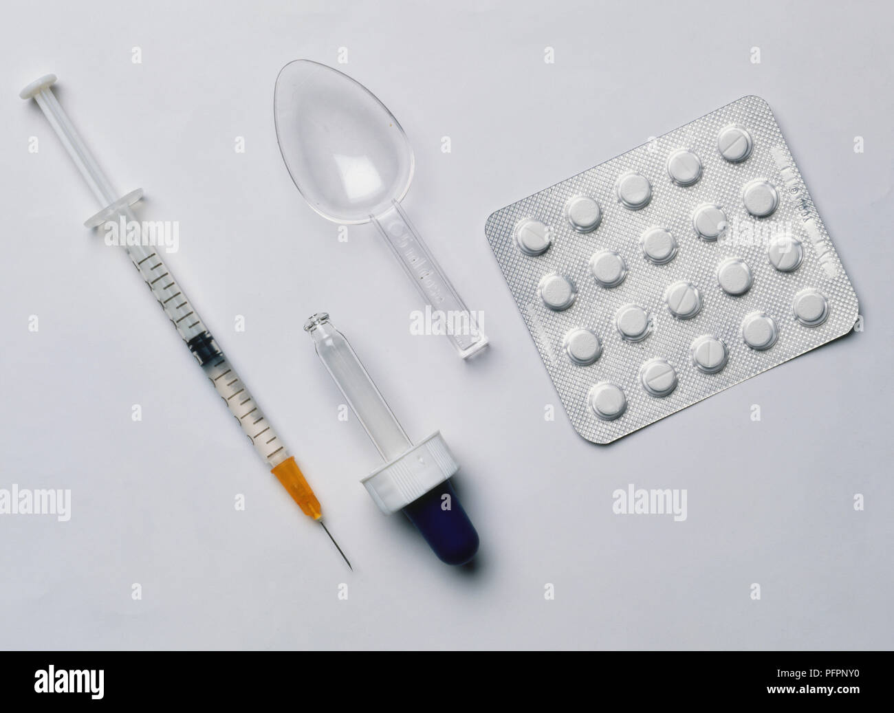 Medical supplies including syringe, applicator, spoon and tablets Stock ...