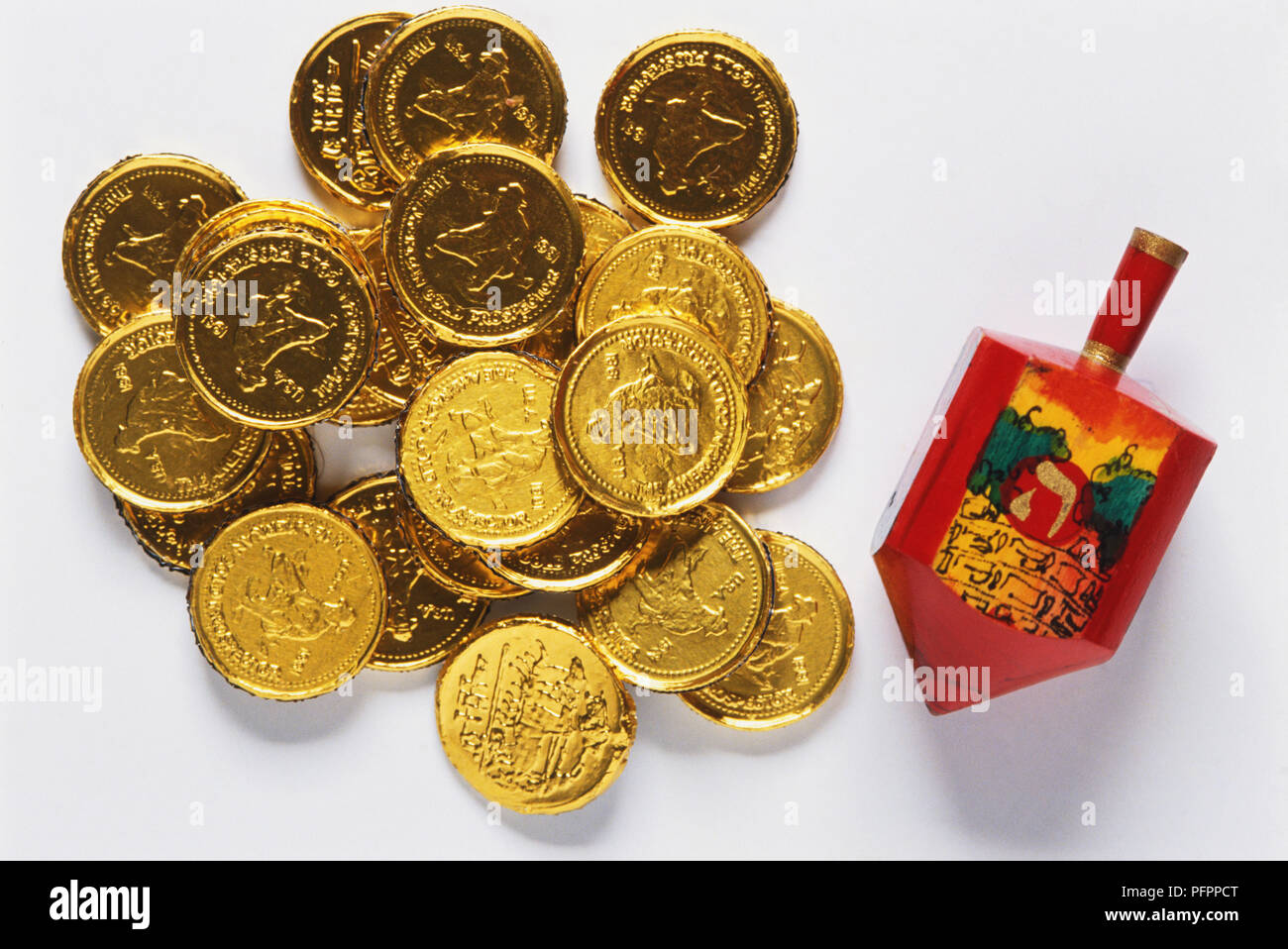 Toy gold coins and a spinning top Stock Photo - Alamy