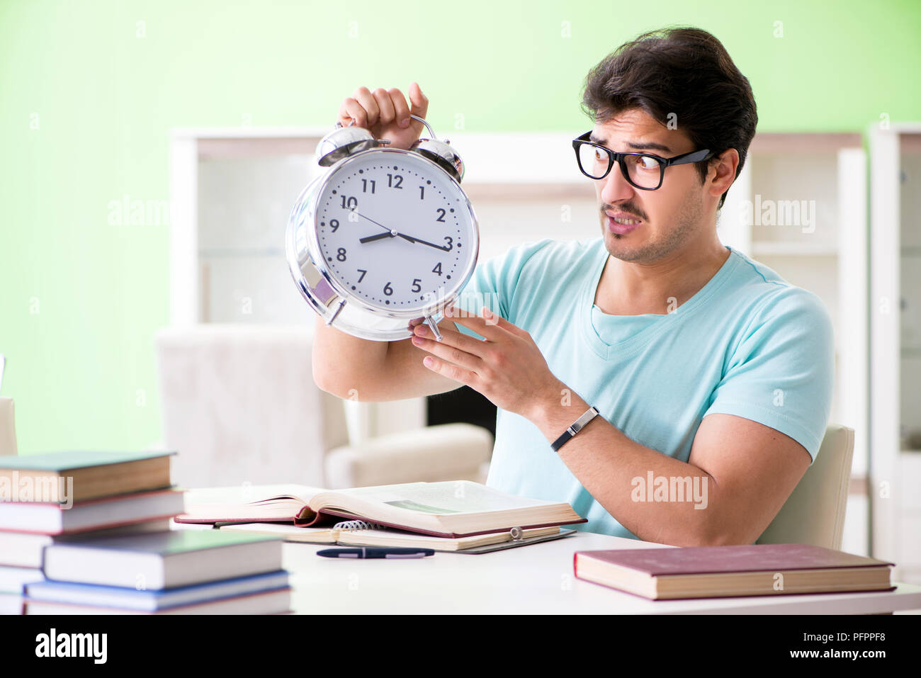 Student preparing for university exams at home in time management ...