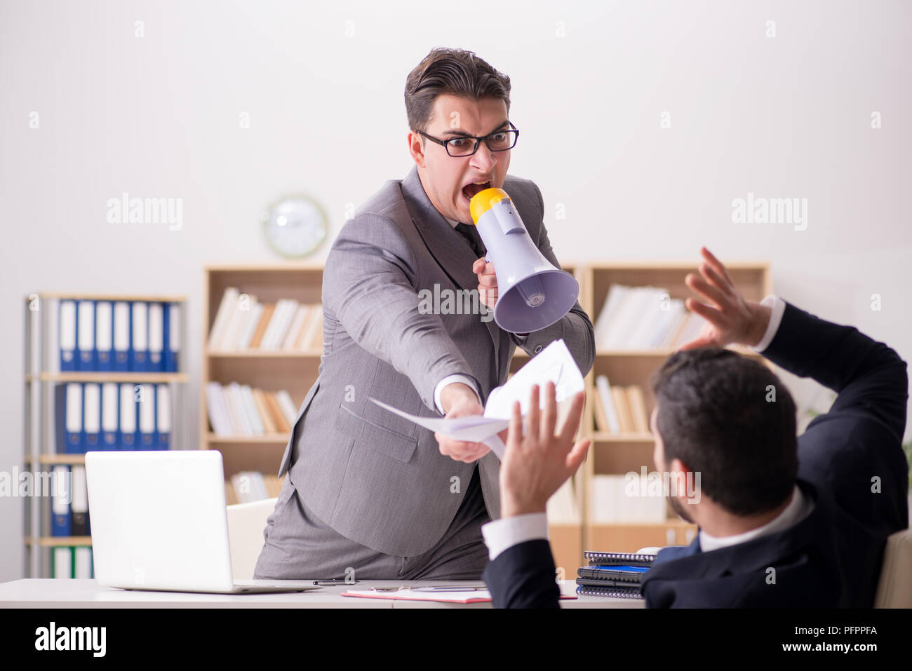 Angry boss shouting at his employee Stock Photo - Alamy