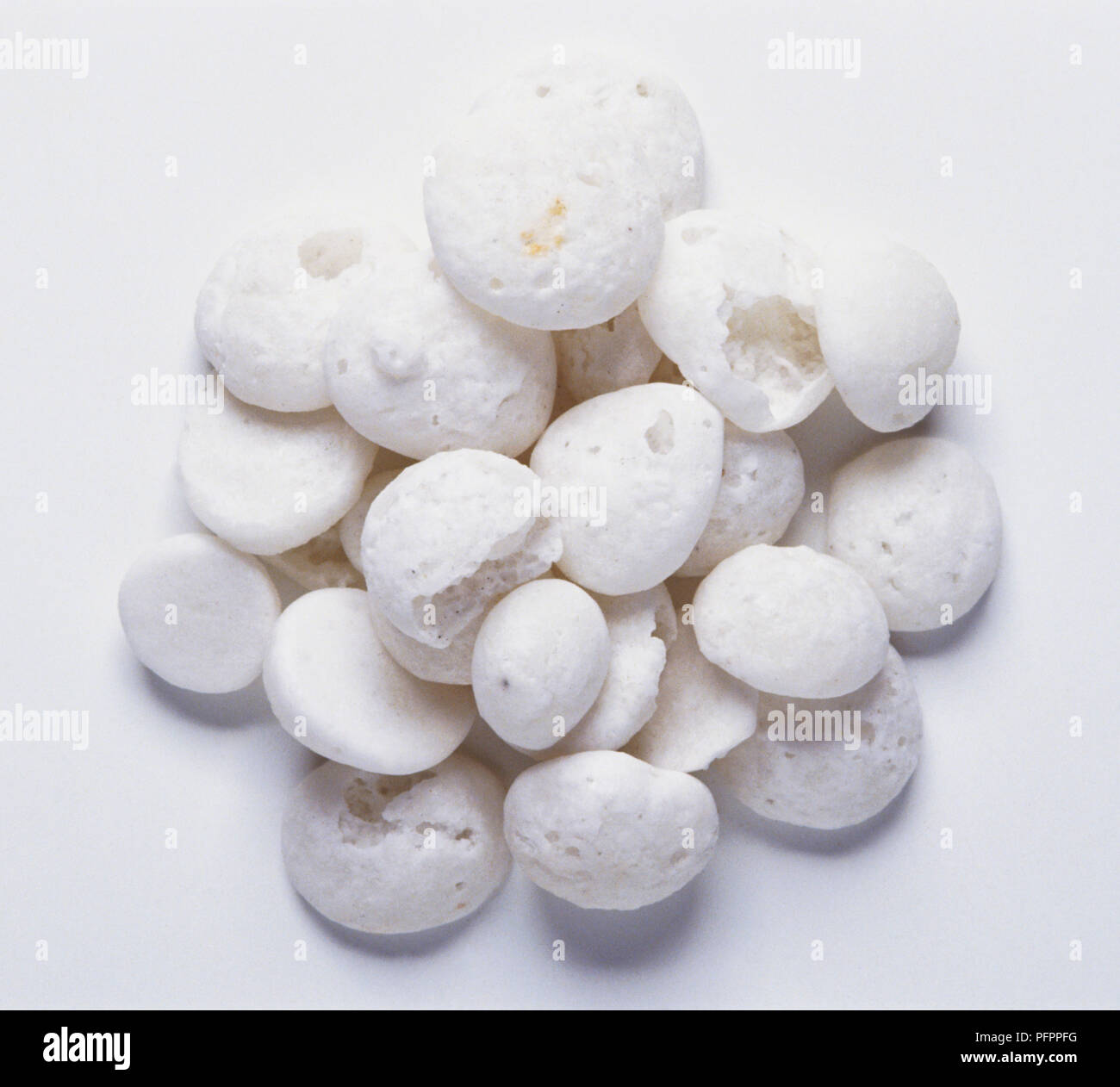 Sugar discs that look like white pebbles in a pile Stock Photo - Alamy