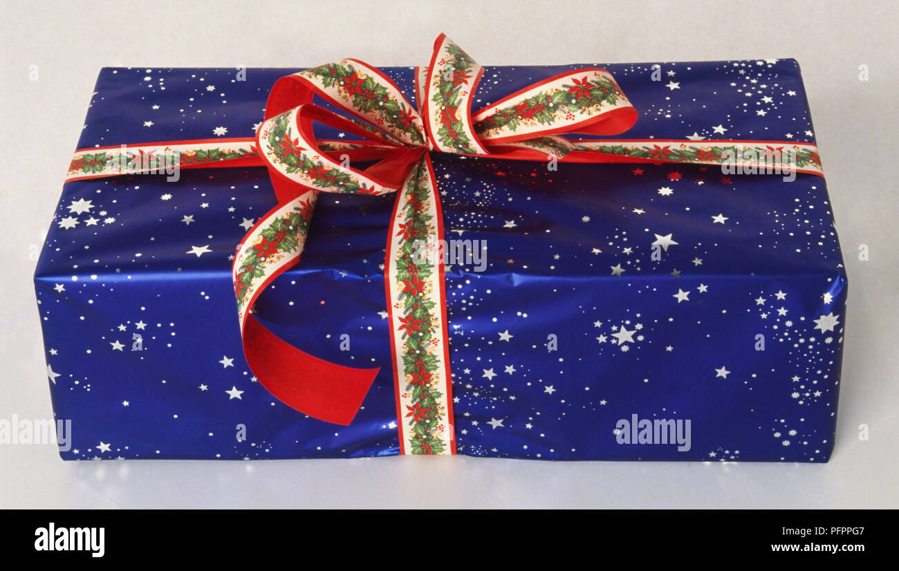 Blue present with white, red and green ribbon Stock Photo - Alamy