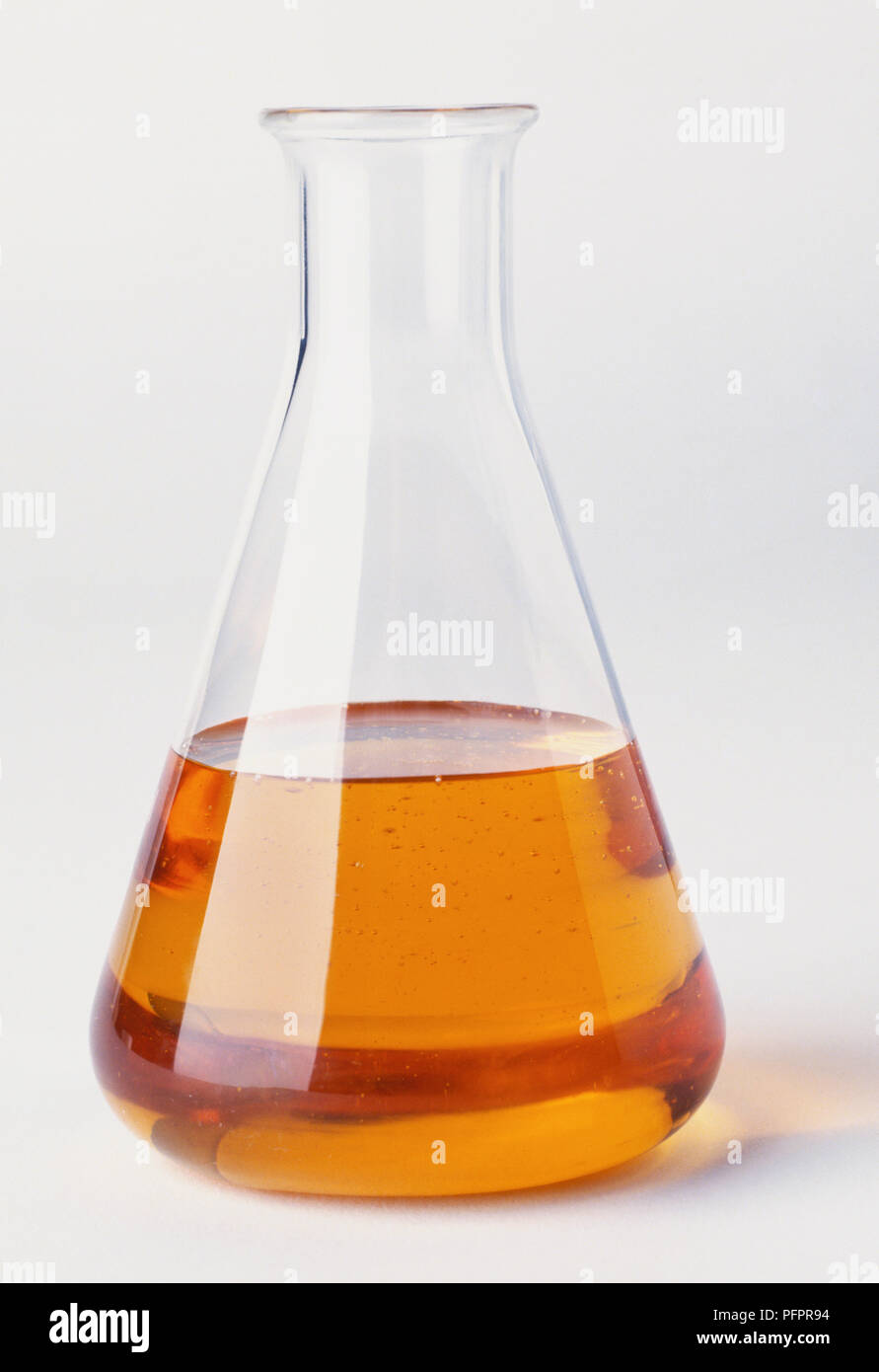 Yellow chemical in a beaker Stock Photo - Alamy