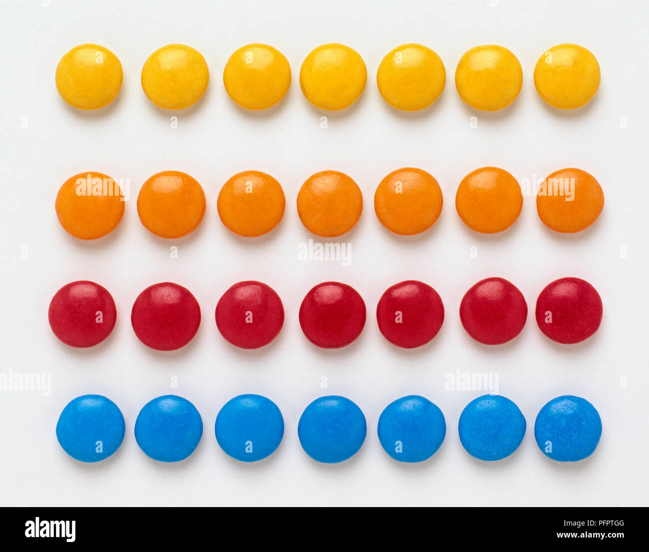 Rows of colourful round sweets Stock Photo - Alamy