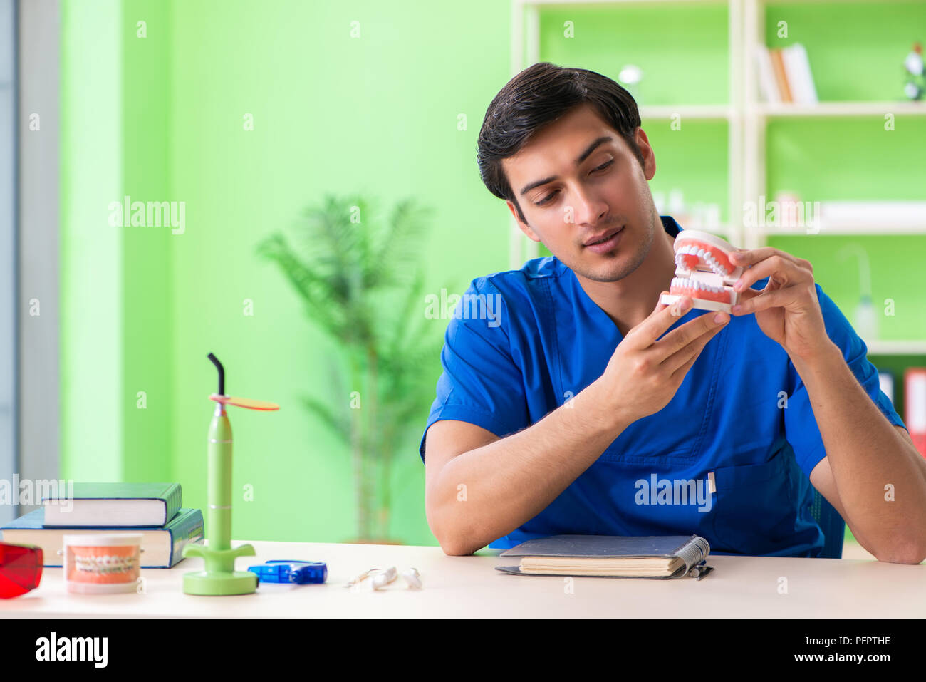Man dentist working on new teeth implant Stock Photo - Alamy
