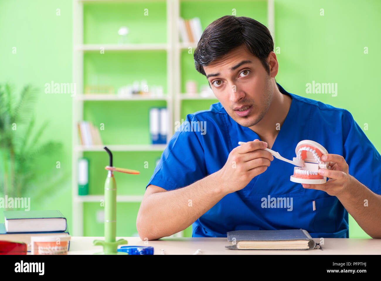 Man dentist working on new teeth implant Stock Photo - Alamy
