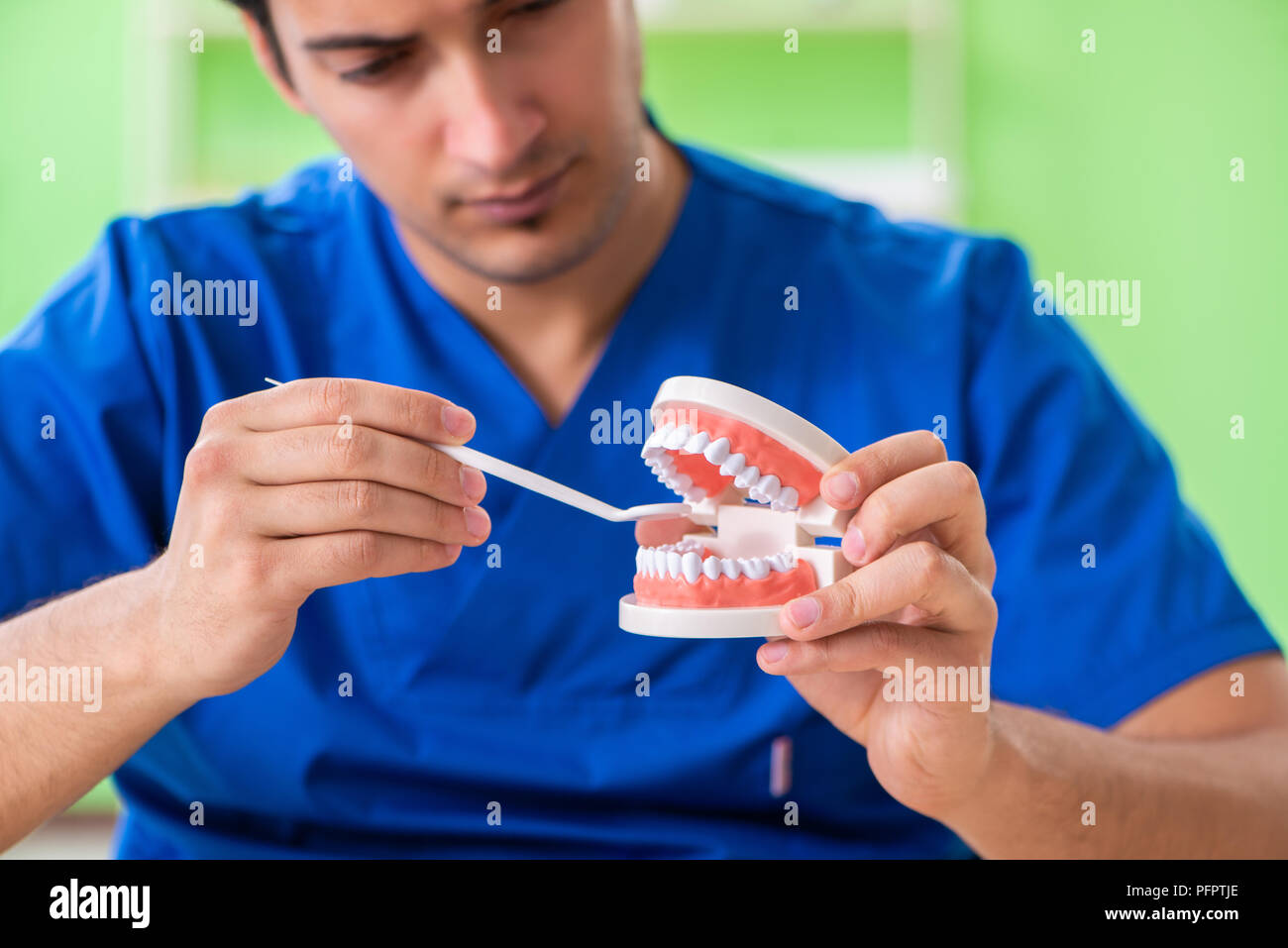 Man dentist working on new teeth implant Stock Photo - Alamy