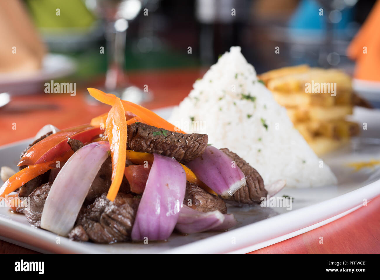 Peruvian food lomo saltado :A salted beef with tomatoes, onion, fried ...