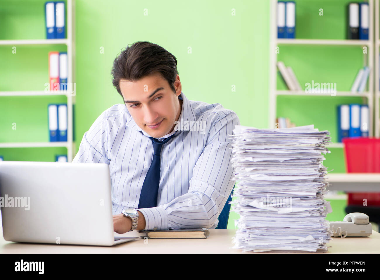 Businessman having problems with paperwork and workload Stock Photo - Alamy
