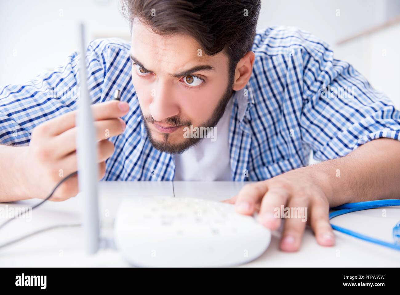 Frustrated young man due to weak internet reception Stock Photo - Alamy