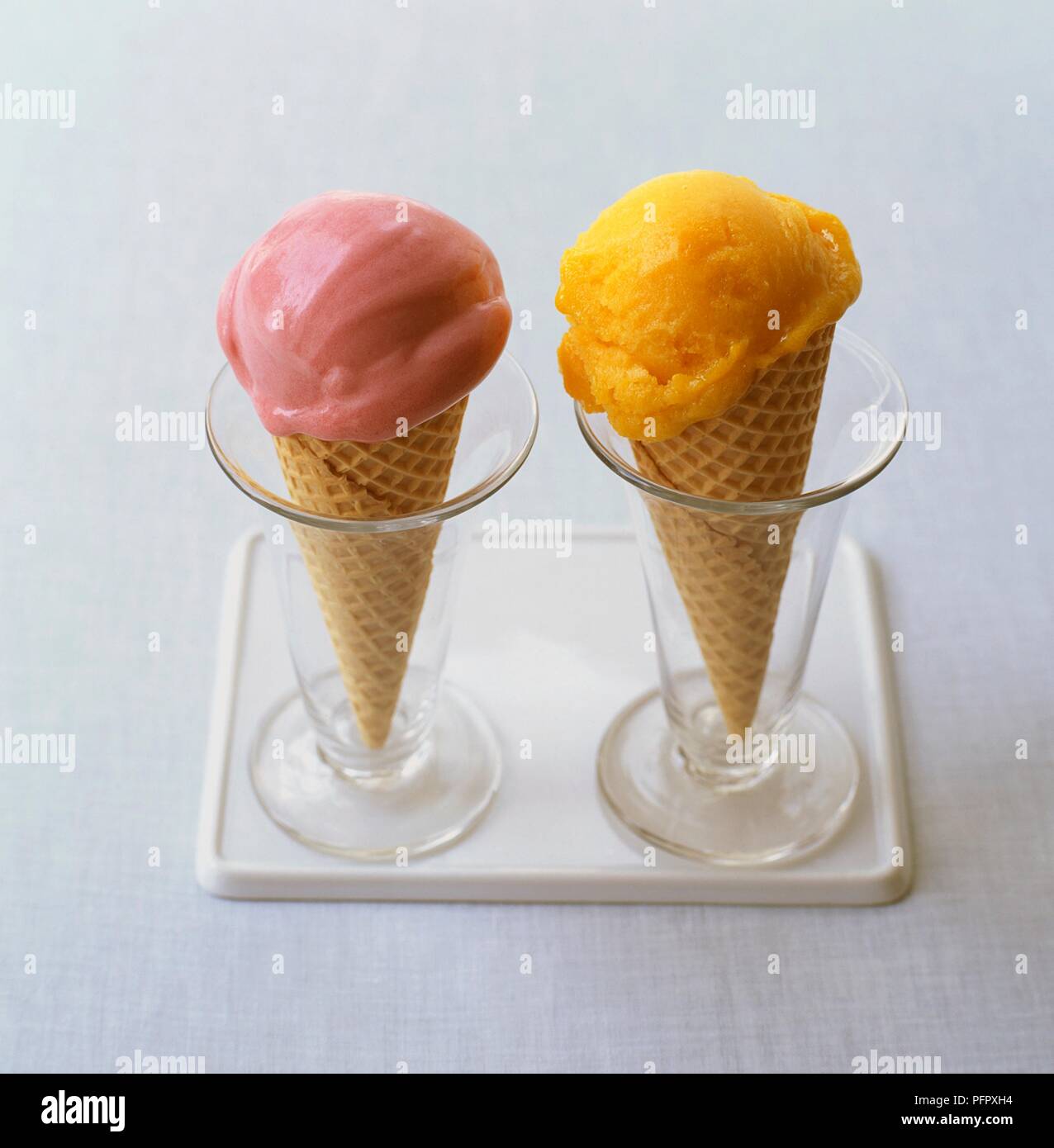Raspberry and mango ice cream cones in tall glasses on tray Stock Photo ...