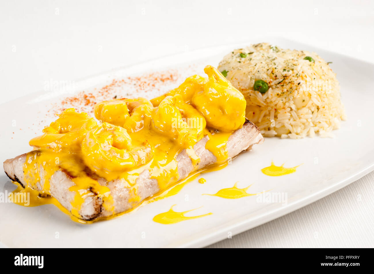 Plate of fried fish in shrimp sauce with rice Stock Photo - Alamy