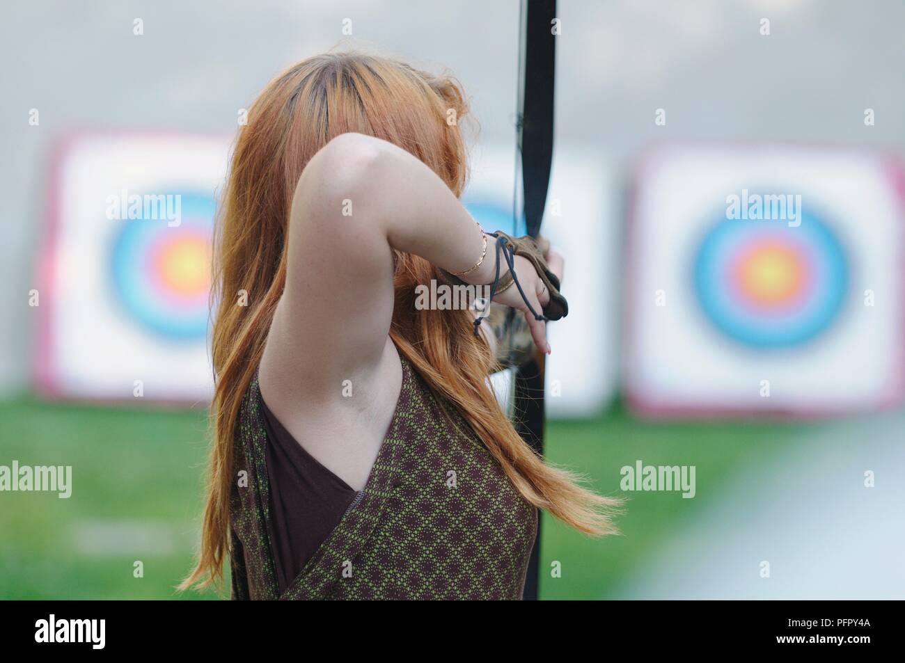 Archer aiming at target Stock Photo - Alamy