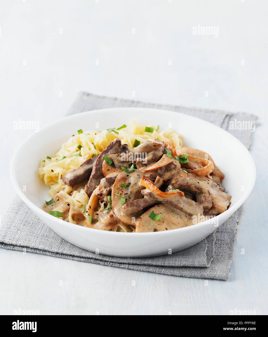 Russian beef saute with tagliatelle pasta in bowl Stock Photo - Alamy
