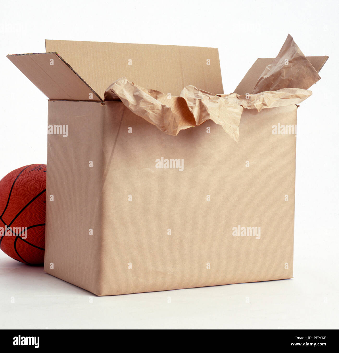 Basketball behind open cardboard box Stock Photo - Alamy
