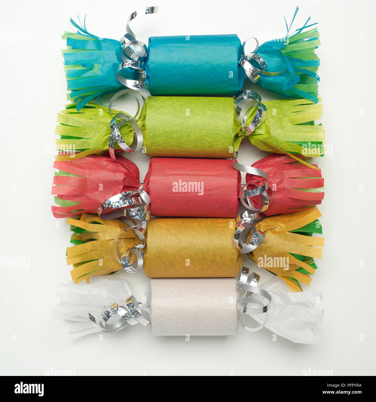 Homemade Christmas crackers tied with silver ribbon Stock Photo - Alamy