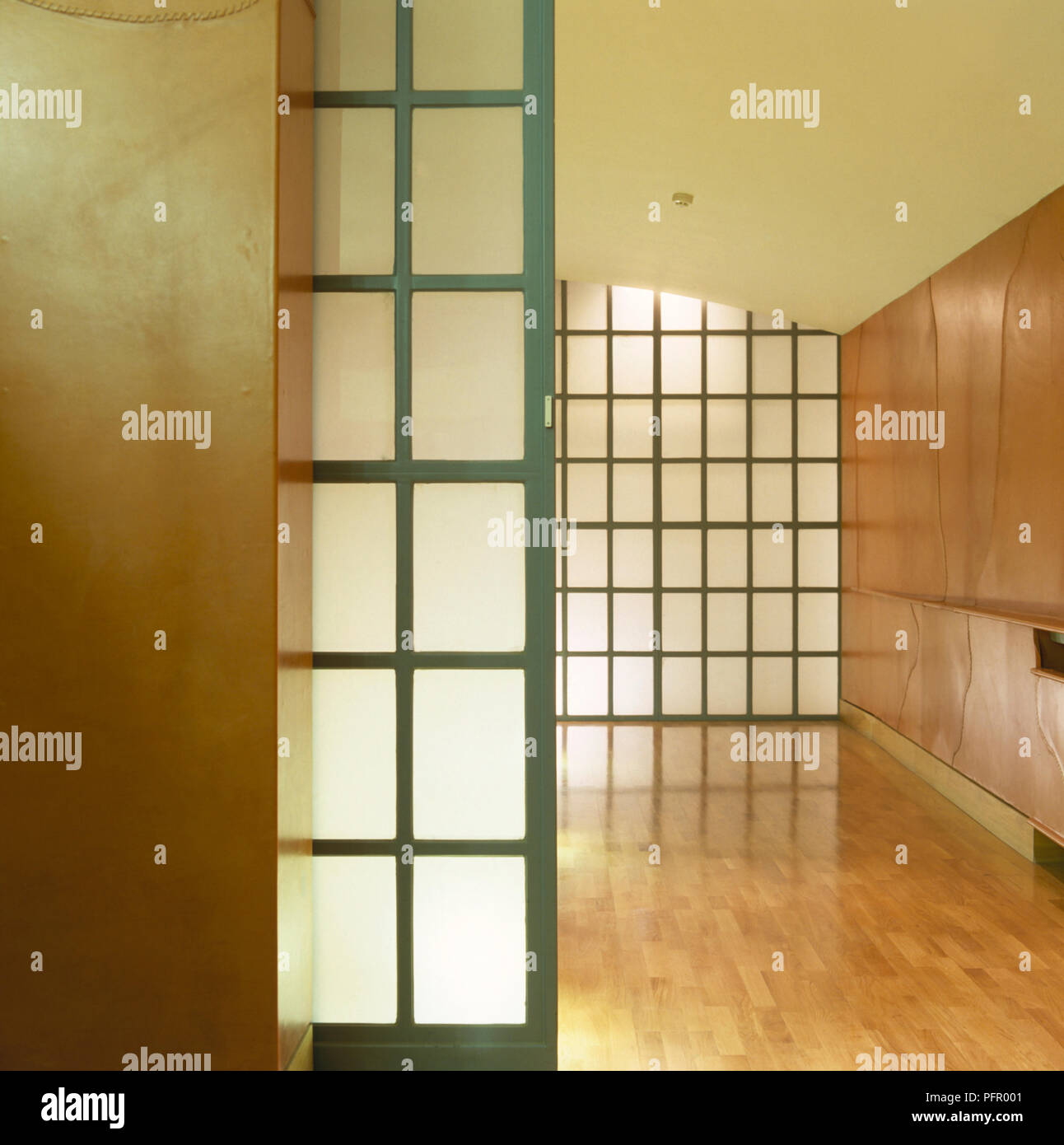 Room with wooden floors and translucent screens of sandblasted glass ...