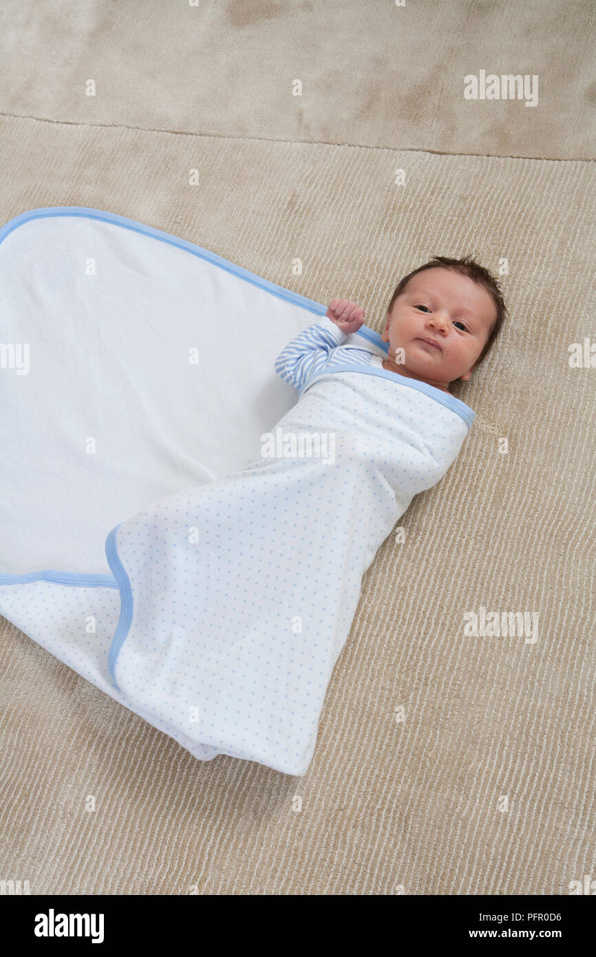 Baby boy being wrapped up in blanket Stock Photo - Alamy