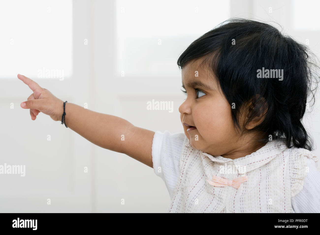 One year old baby girl pointing Stock Photo - Alamy