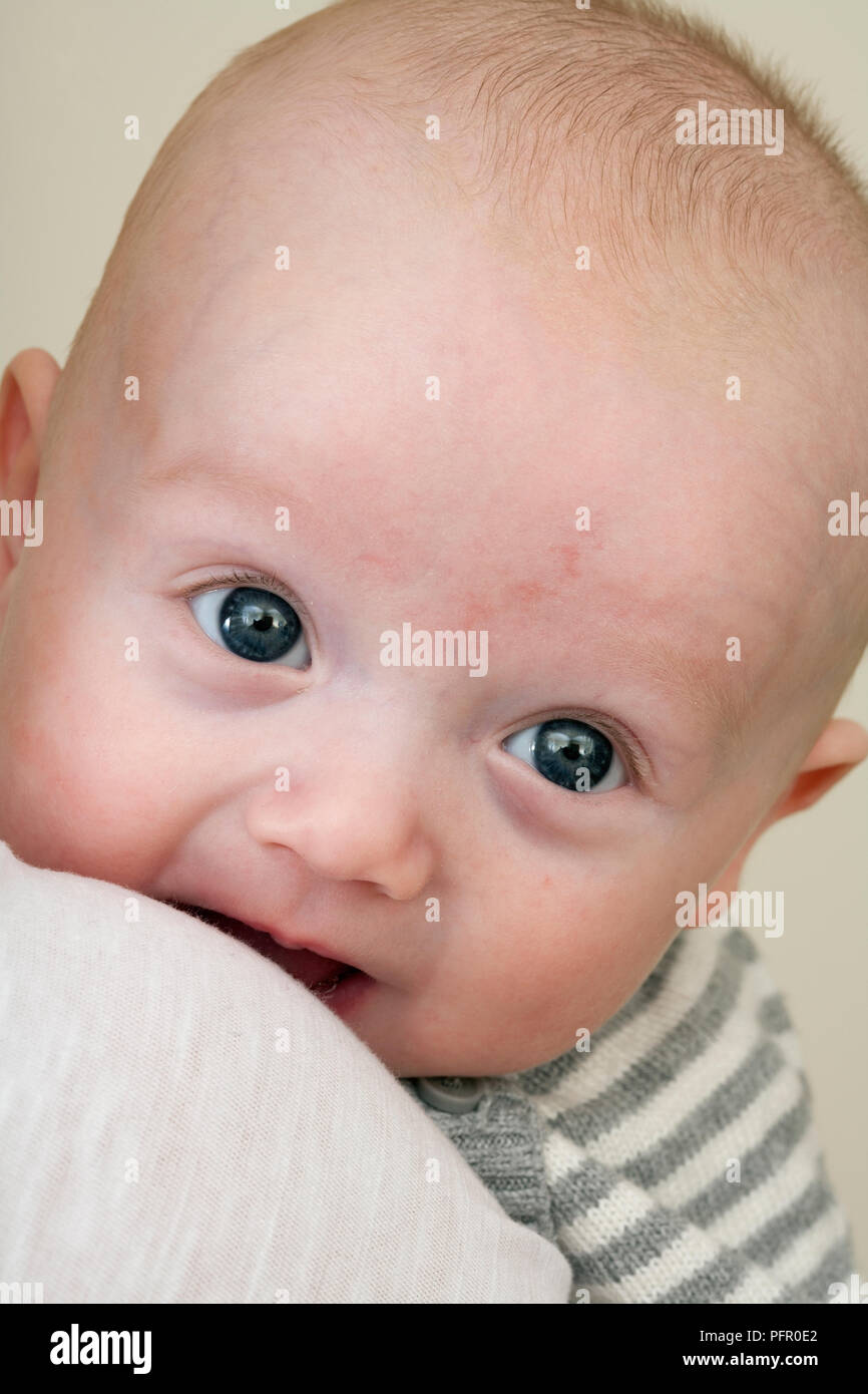 Baby boy looking over shoulder Stock Photo - Alamy