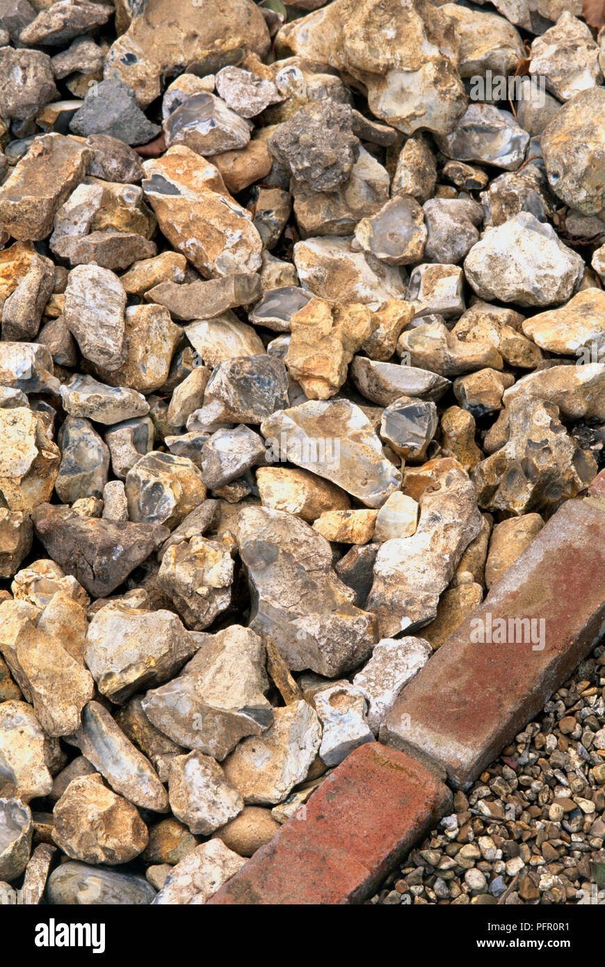 Gravel seperated by stones with brick border in domestic garden Stock ...