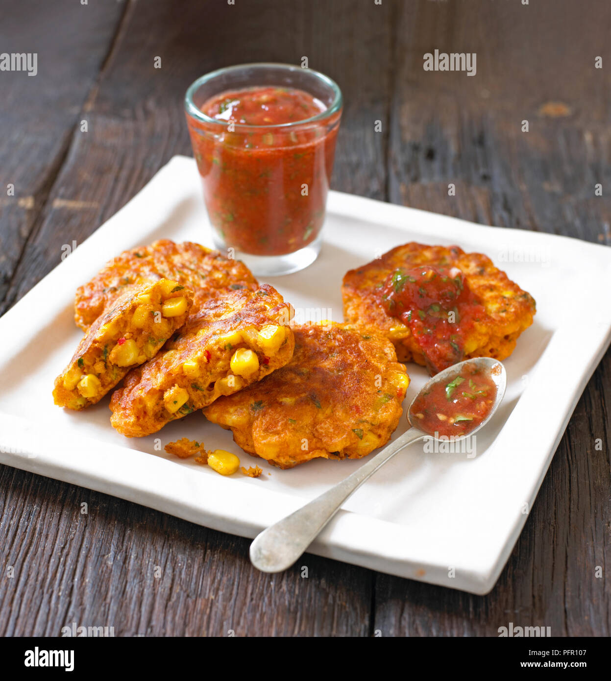 Sweetcorn fritters with tomato and herb relish Stock Photo - Alamy