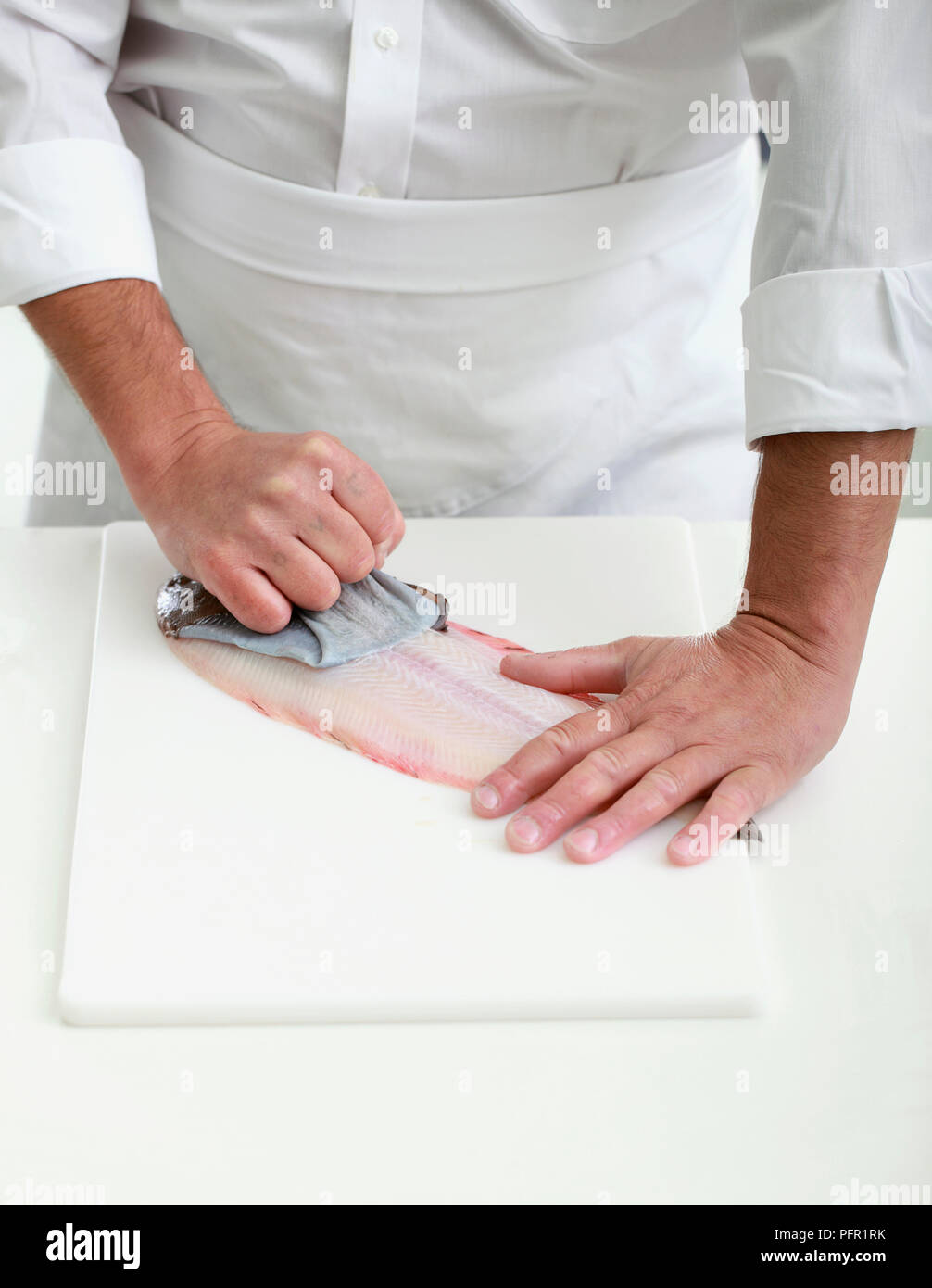 Skinning a Dover sole, pulling skin slowly towards the head Stock Photo ...