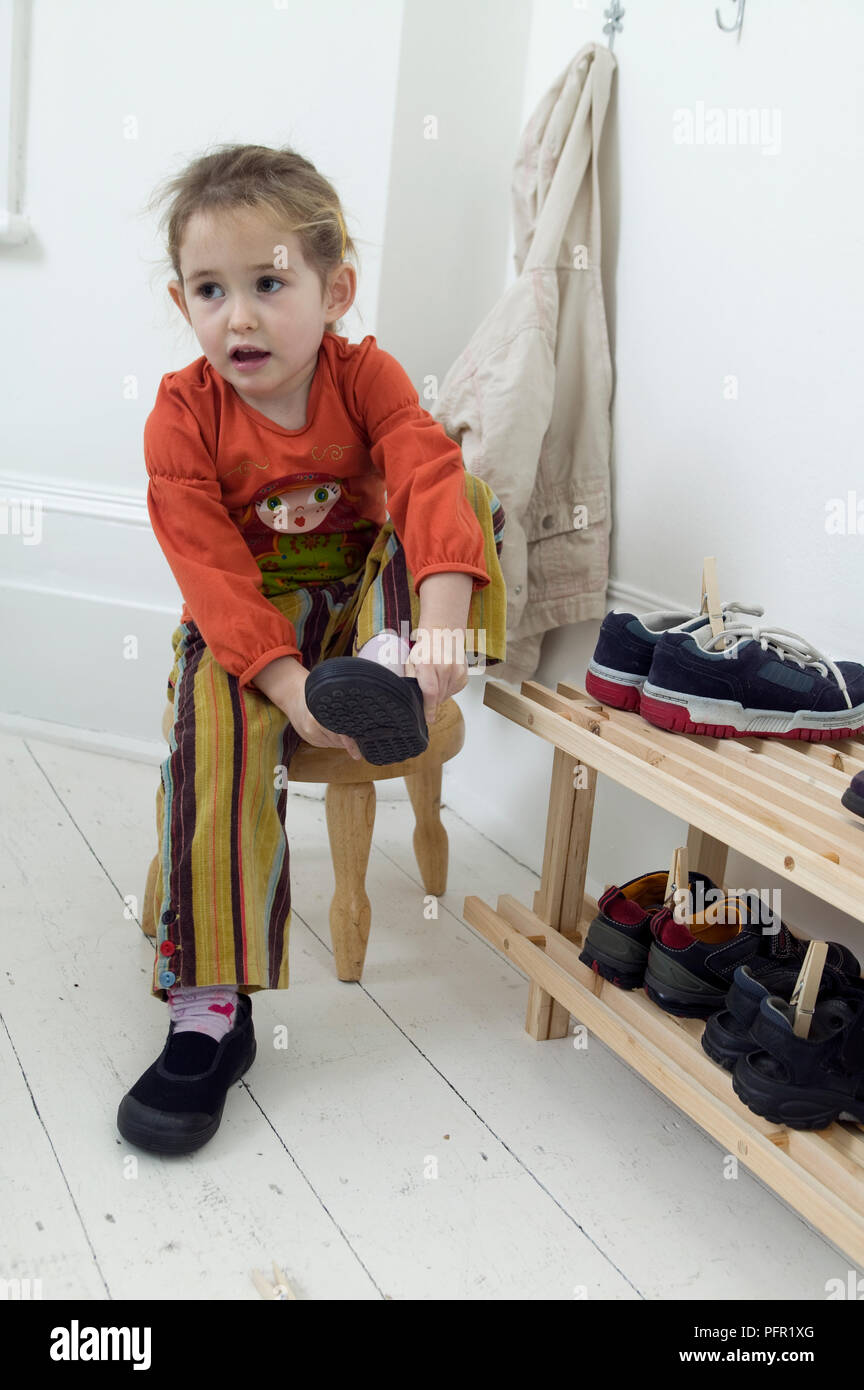 Child Putting On Shoes