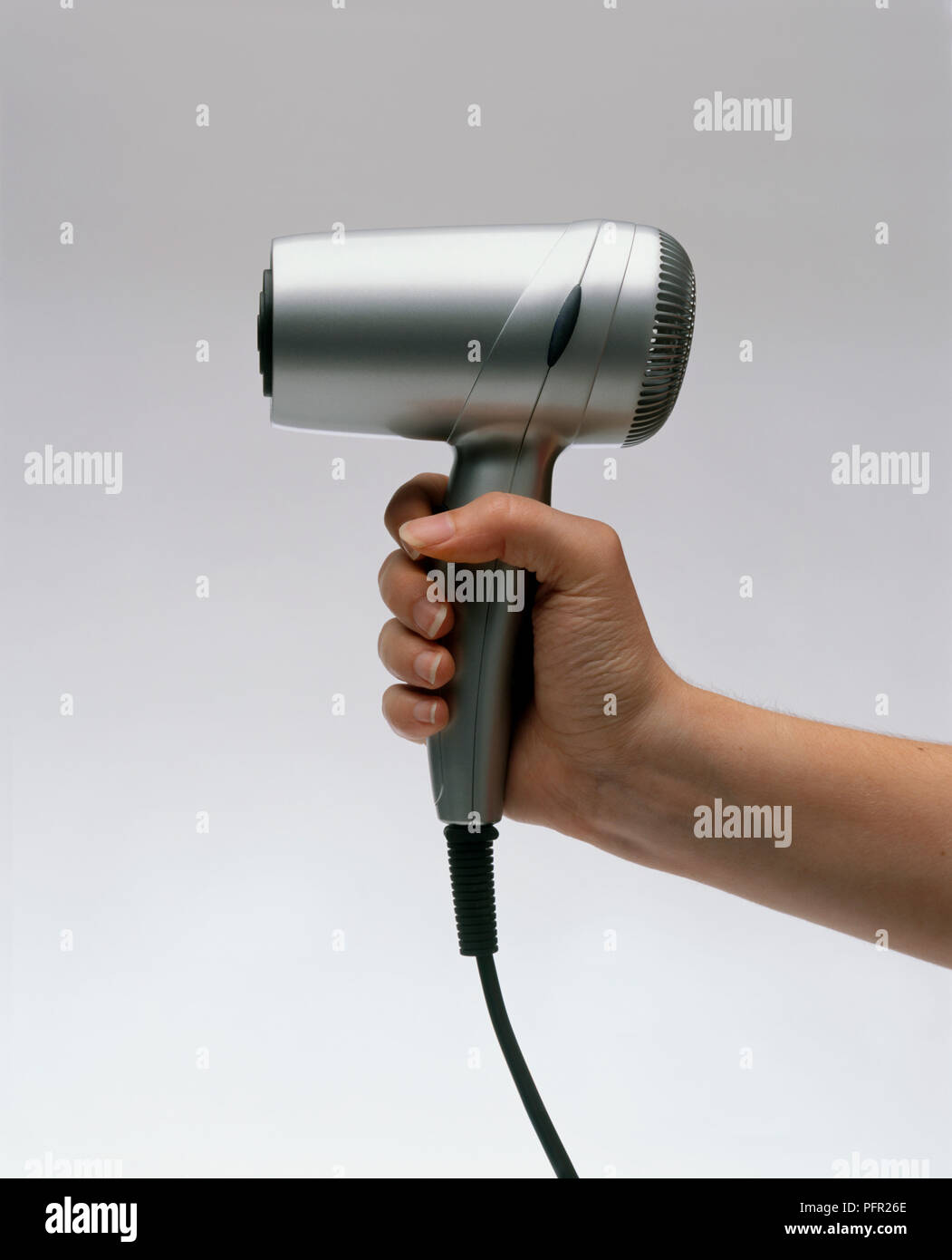 Hand holding hair dryer Stock Photo - Alamy