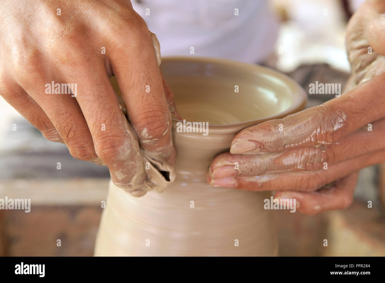 Cambodia, Siem Reap, Khmer Ceramics Centre, artisan making a ceramic ...