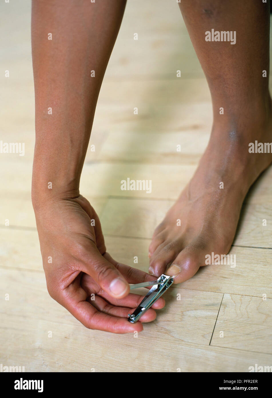 Hand clipping toenails, close-up Stock Photo - Alamy
