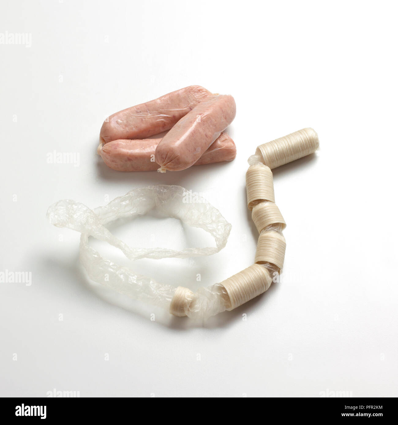 String of raw pork sausages and collagen casings Stock Photo - Alamy