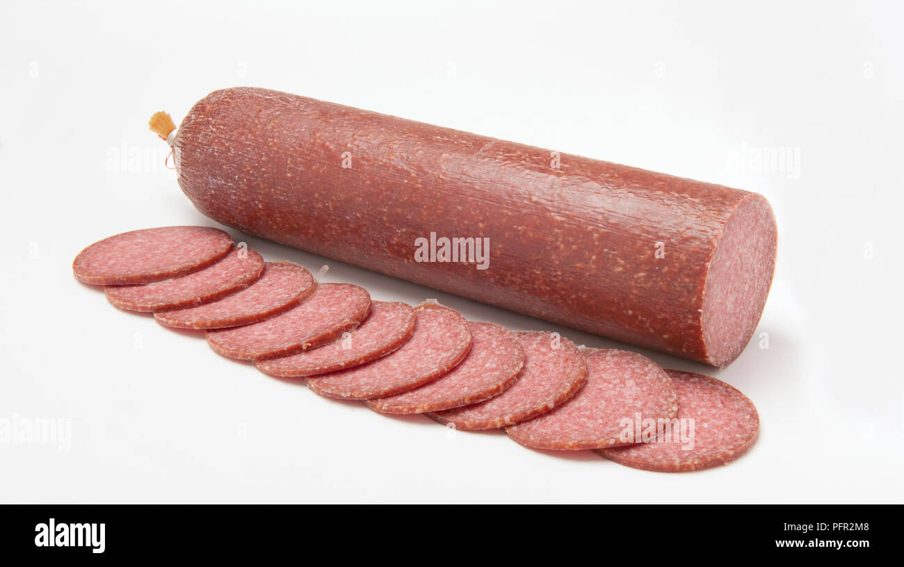 Whole and sliced German Cervelatwurst pork and beef sausage Stock Photo ...