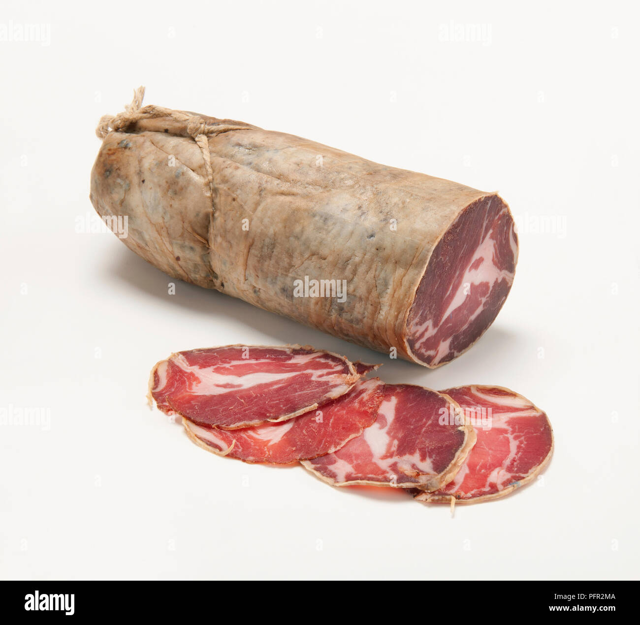 Whole and sliced Italian Capocollo dry-cured pork sausage Stock Photo ...