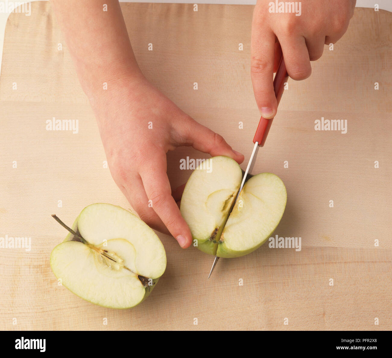 Child slicing apple with a sharp knife Stock Photo - Alamy