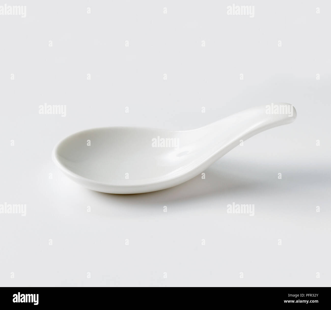 White ceramic spoon Stock Photo - Alamy