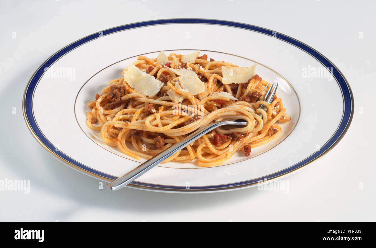 Portion of spaghetti bolognaise with parmesan shavings Stock Photo - Alamy