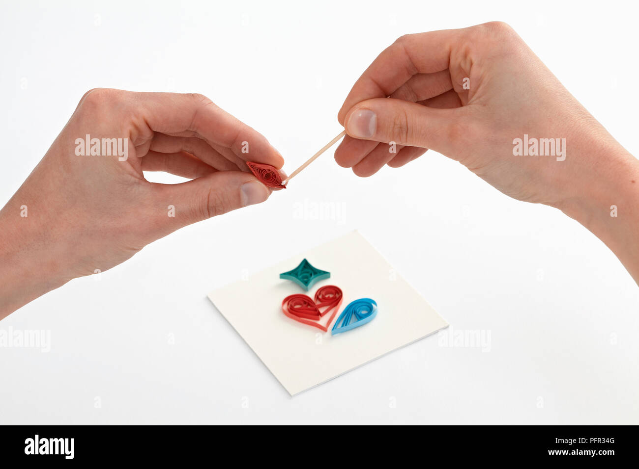 Gluing quilled shapes to a background, using transparent PVA glue ...