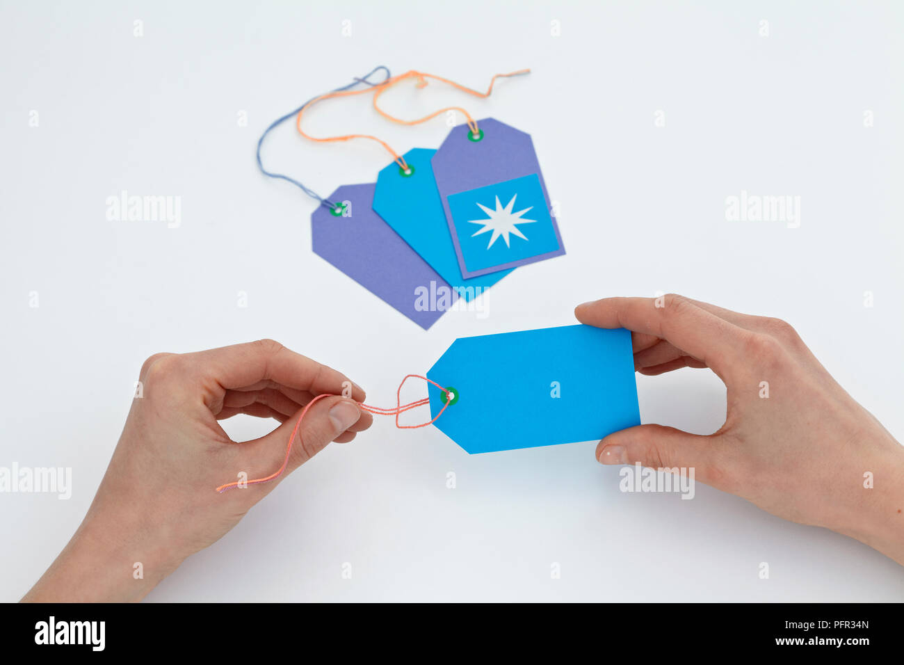 Thread through paper hi-res stock photography and images - Alamy