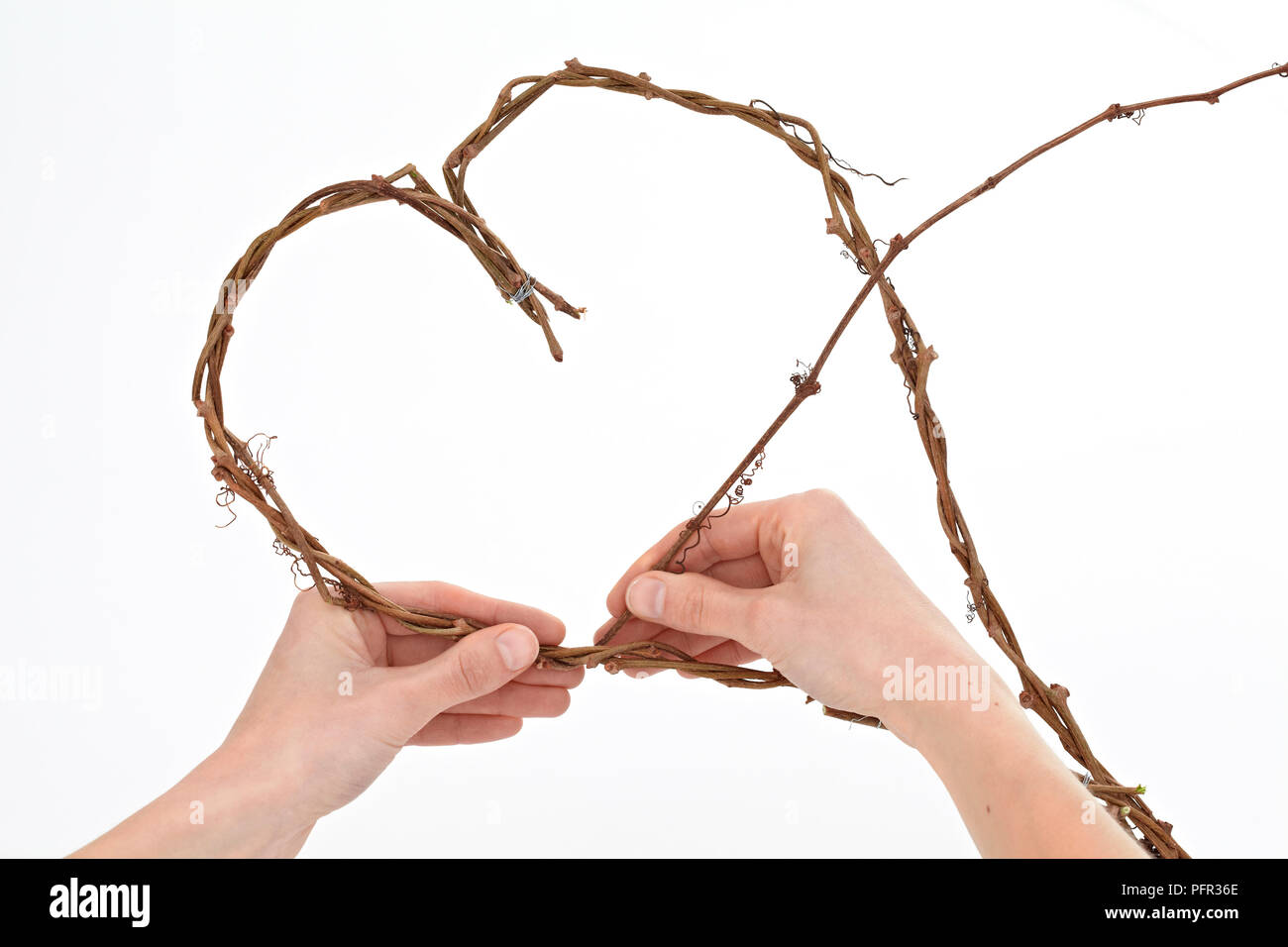 Making a willow heart Stock Photo - Alamy