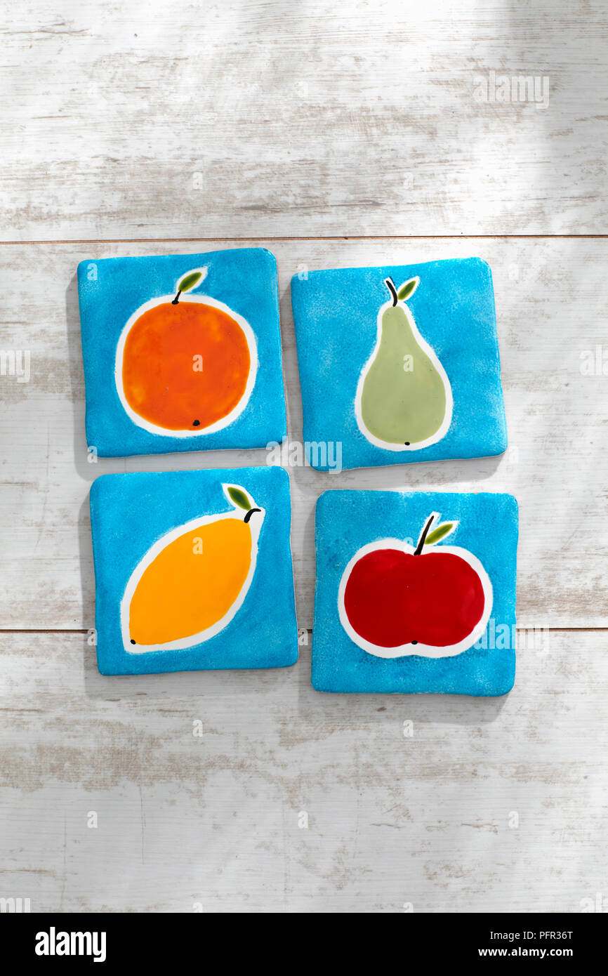 Four ceramic painted tiles showing different fruits Stock Photo - Alamy