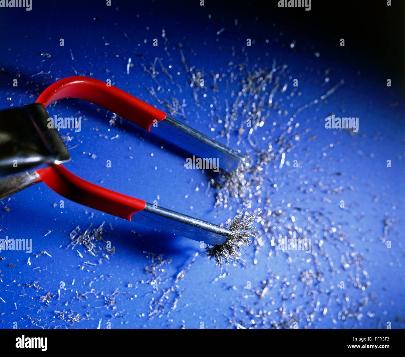 Magnet attracting metal files Stock Photo - Alamy