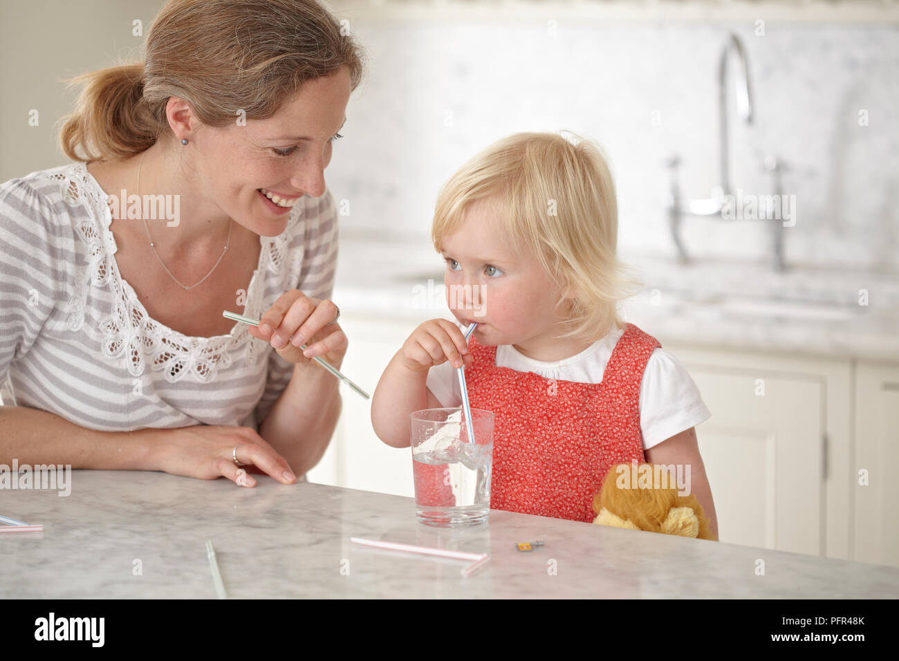 Woman drinking water through straw hi-res stock photography and images ...
