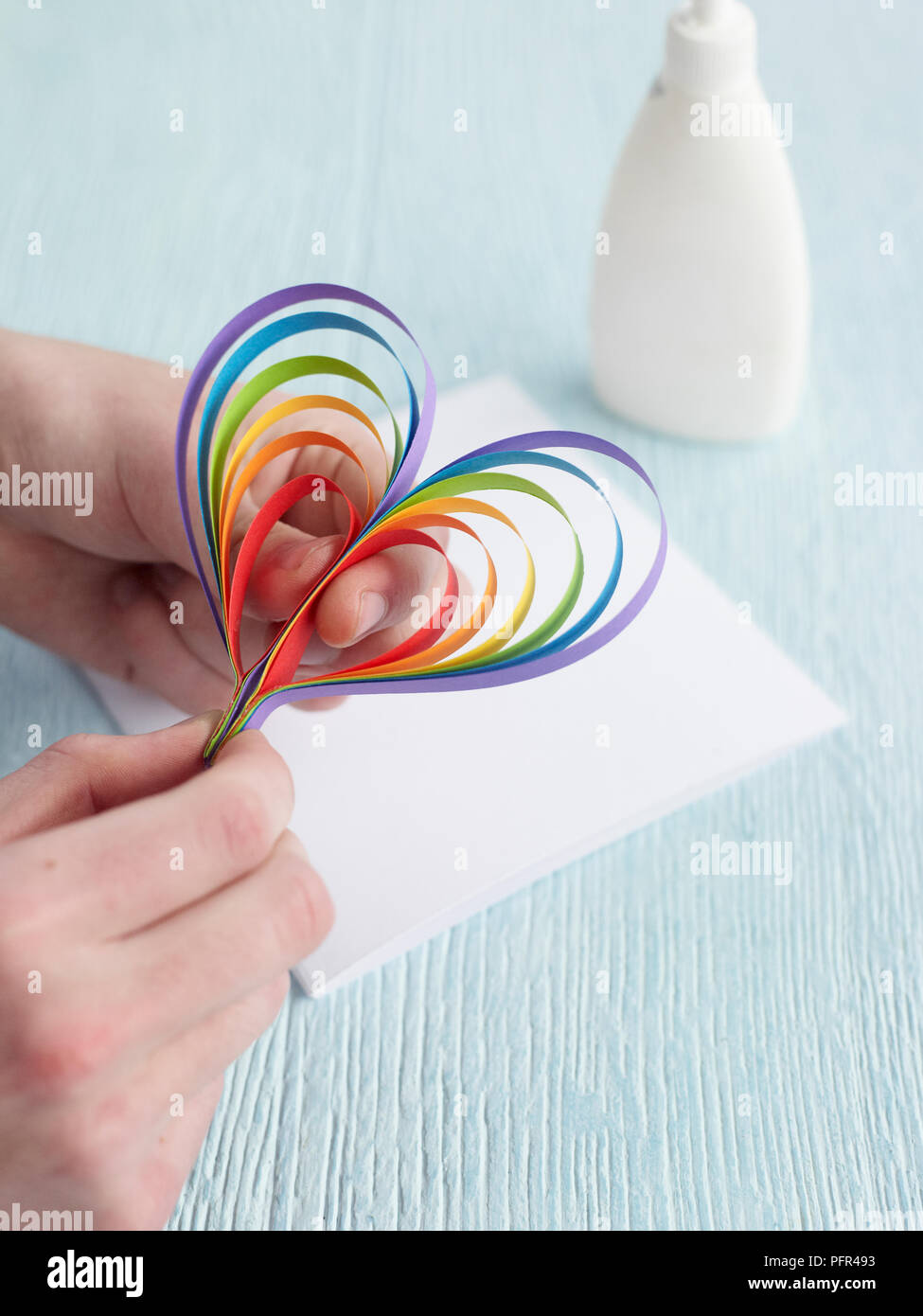 Making a heart card, Bending colourful strips into loops to make heart ...