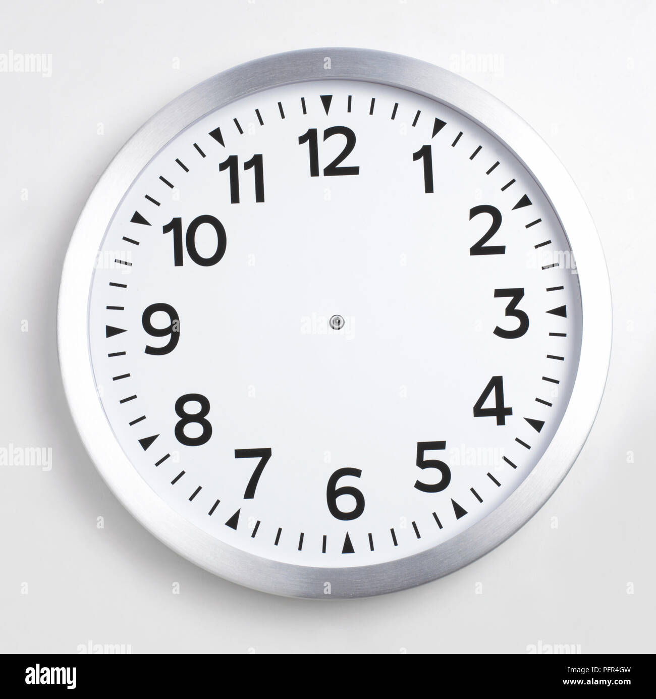 Silver clock with hands missing Stock Photo - Alamy