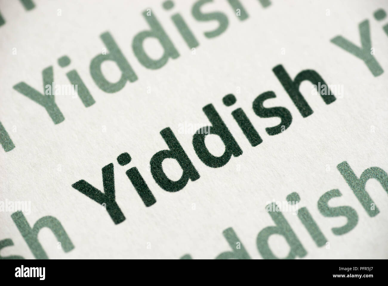 word Yiddish language printed on white paper macro Stock Photo - Alamy